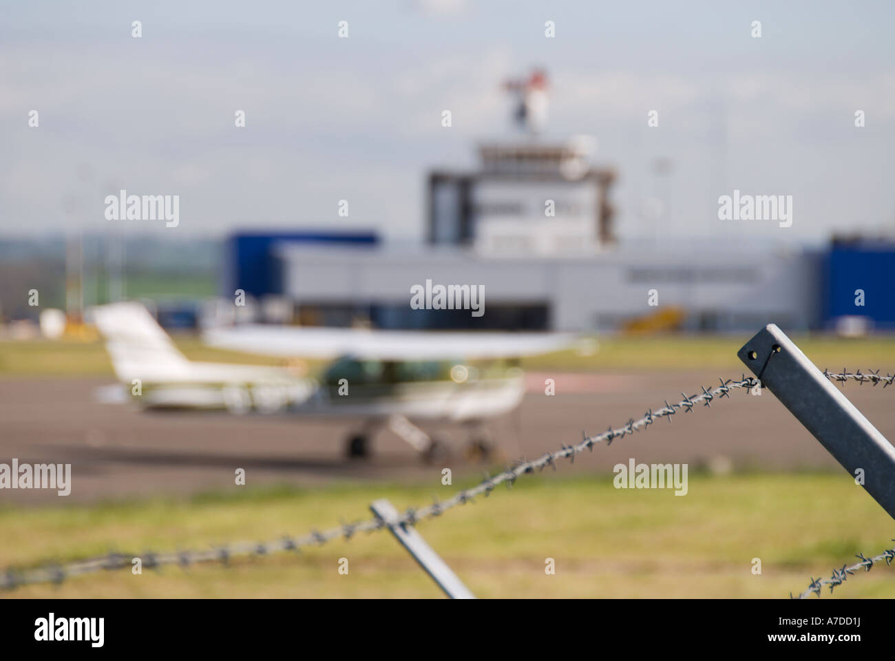 A security fence with Airport Terminal Building and aircraft out of ...