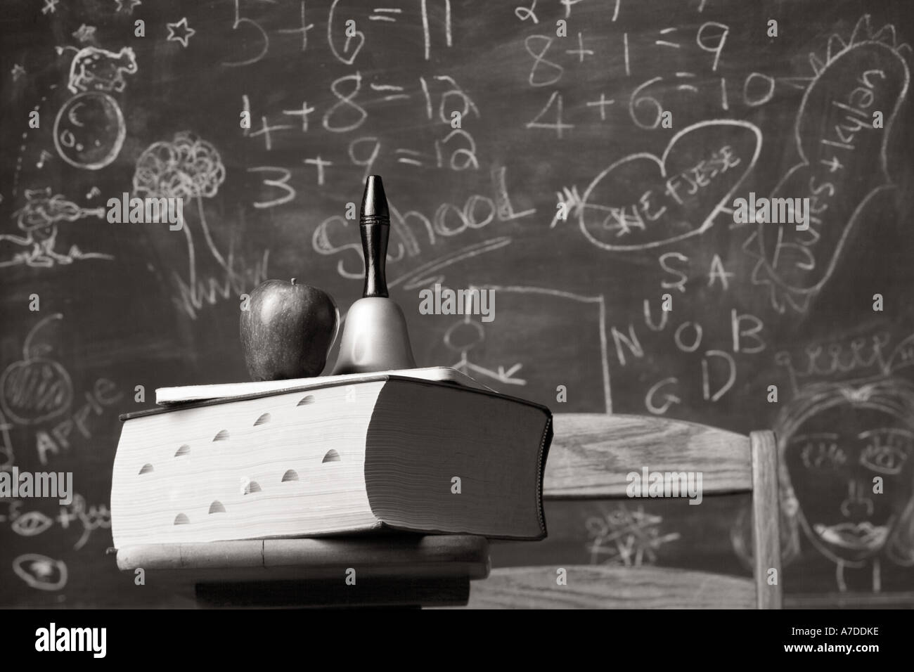 Black and white classroom still life with blackboard, dictionary, bell ...