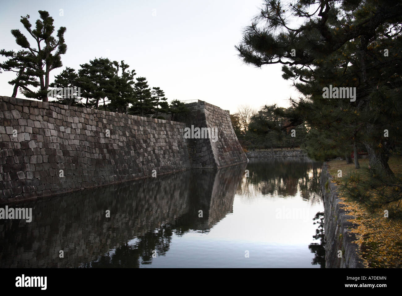 Sloping hand cut stone block outer walls and moat of Nijo Castle Nijo ...