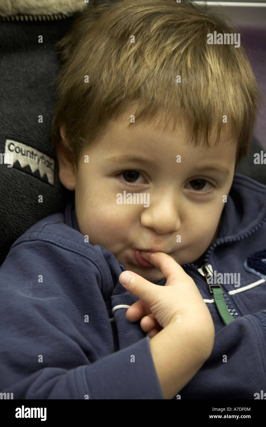 Young boy child looking coy or cute CJWH Stock Photo - Alamy