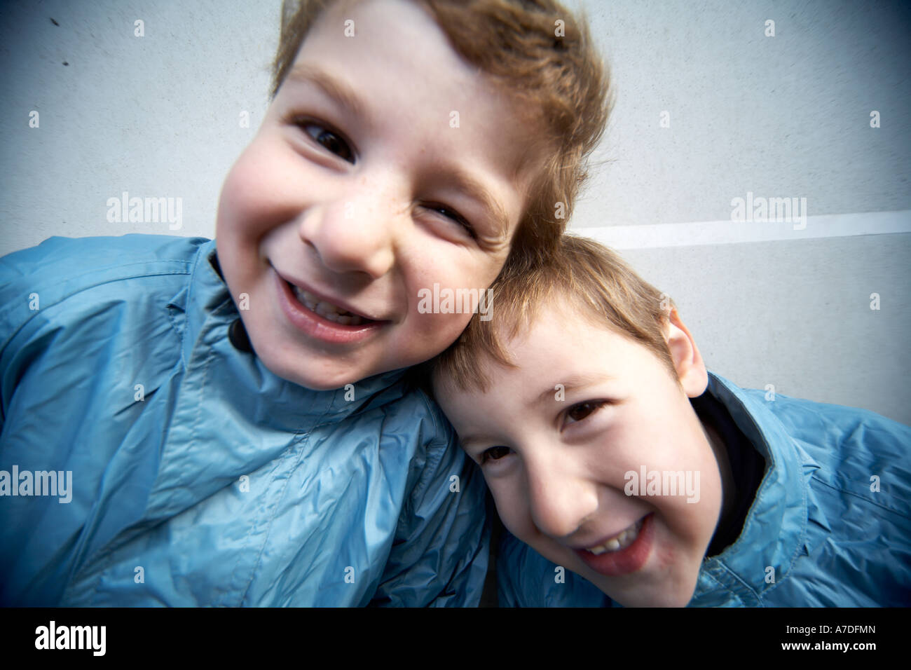 Two young boys with faces distorted by wide angle lens CJWH NAOH Stock ...