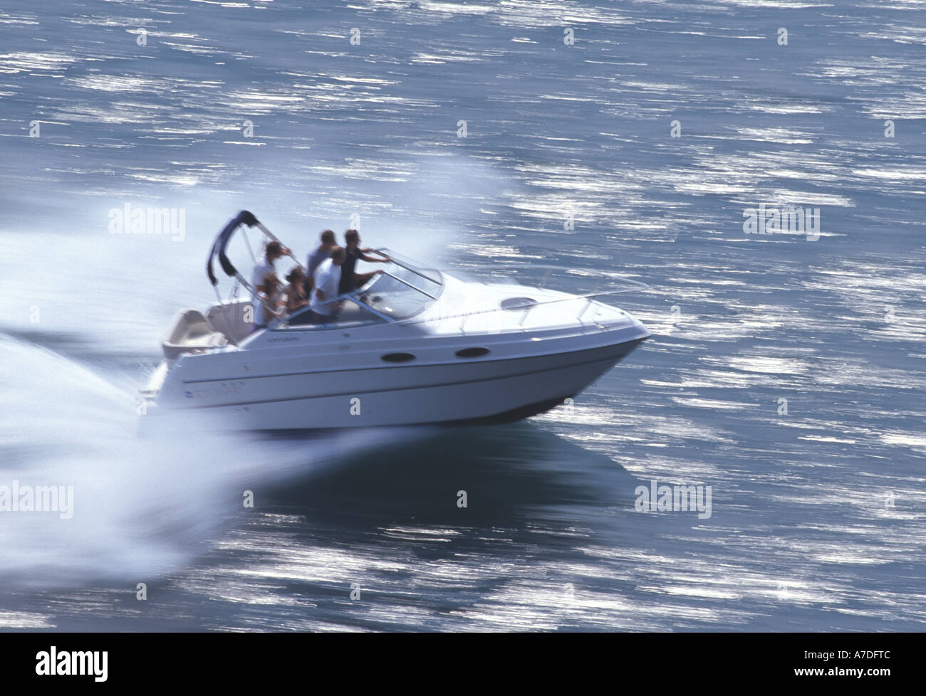 Speedboat racing across water Devon England Stock Photo - Alamy
