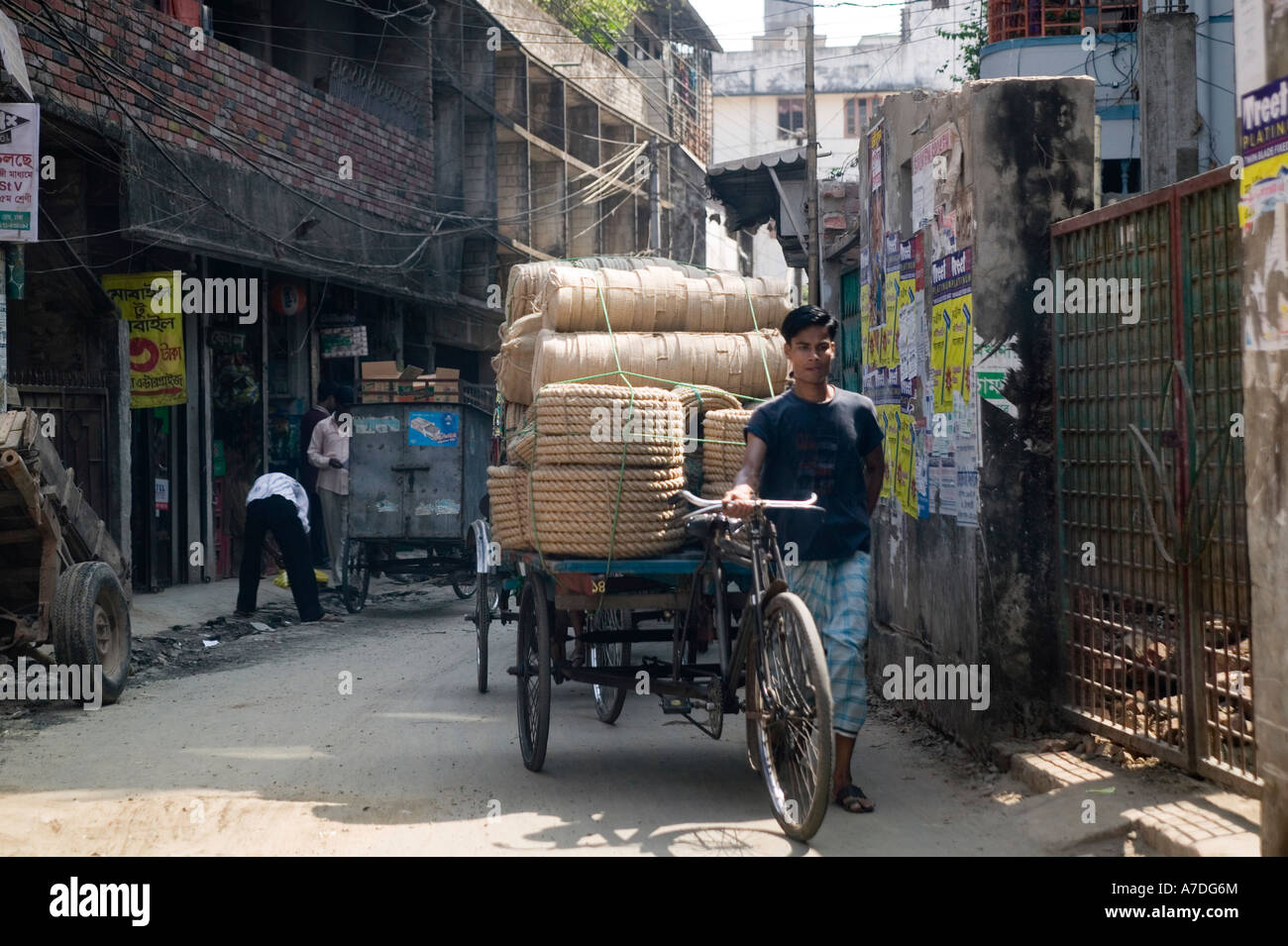 A rickshaw puller walking the heavy load on his rickshaw Dhaka ...