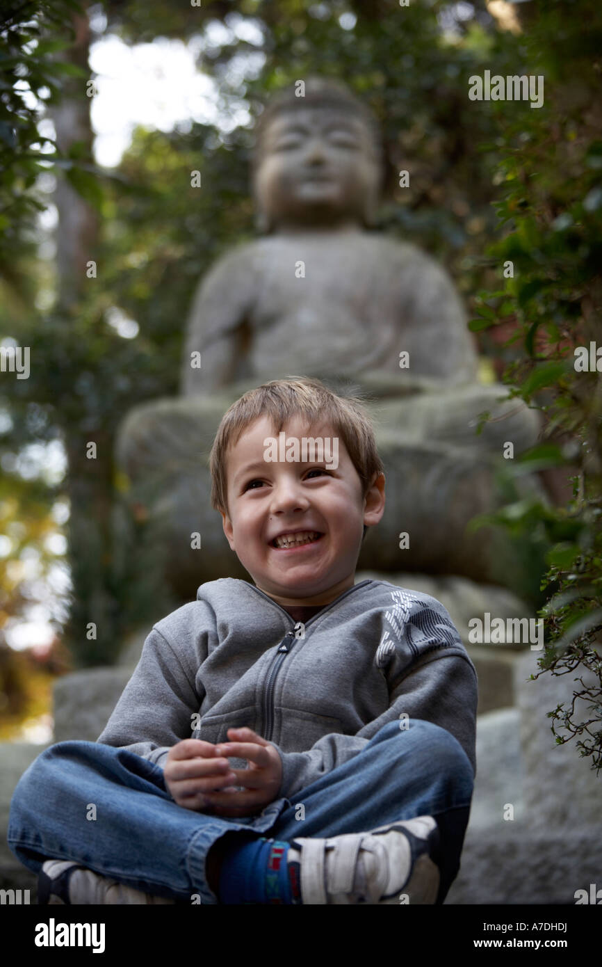 Young western boy child smiling in front of Buddha statue in Ryoanji ...