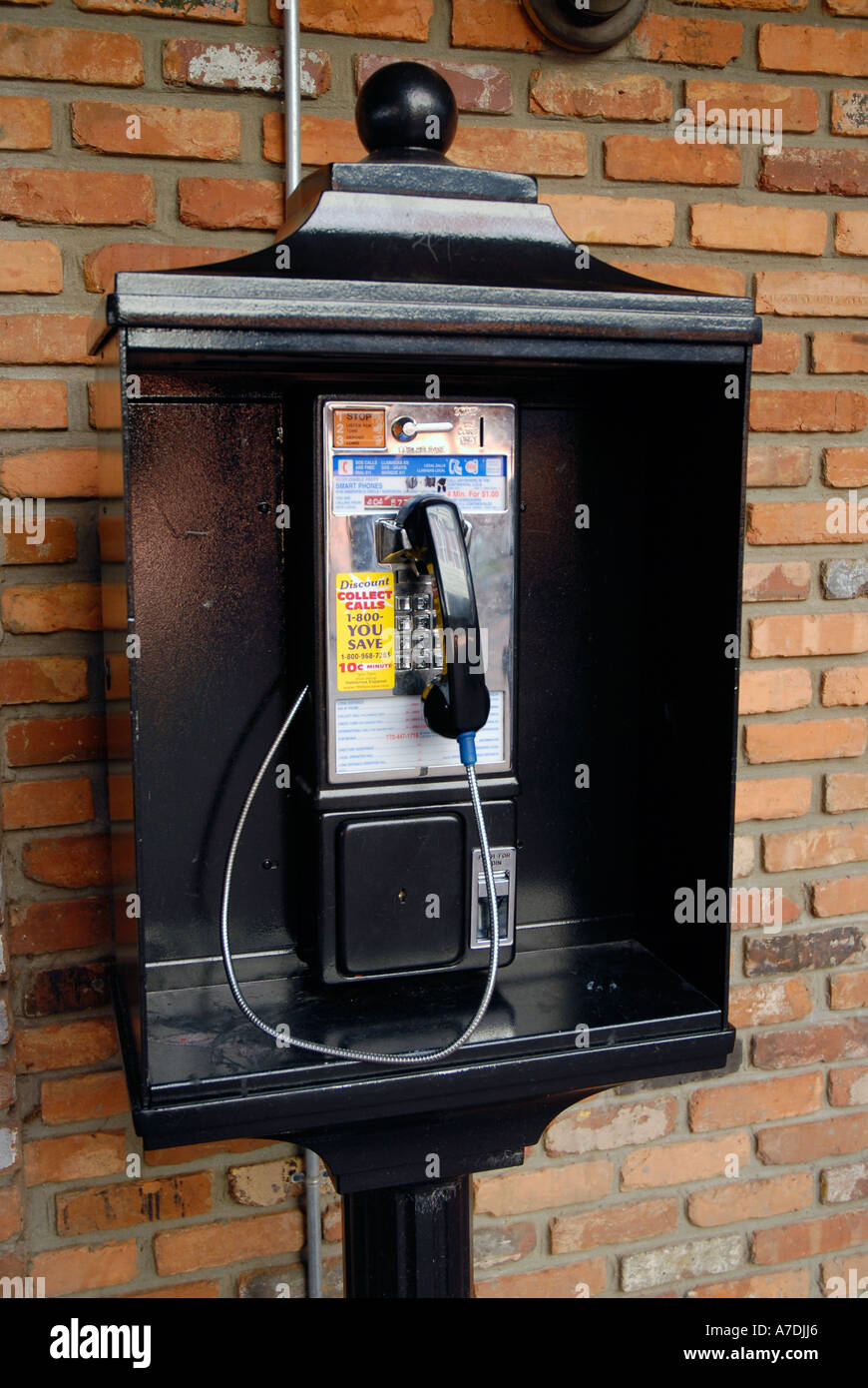 pay telephone booth against a brick wall Stock Photo - Alamy