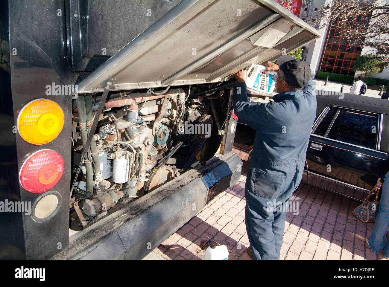 Black male mechanic works to repair a bus engine Stock Photo - Alamy