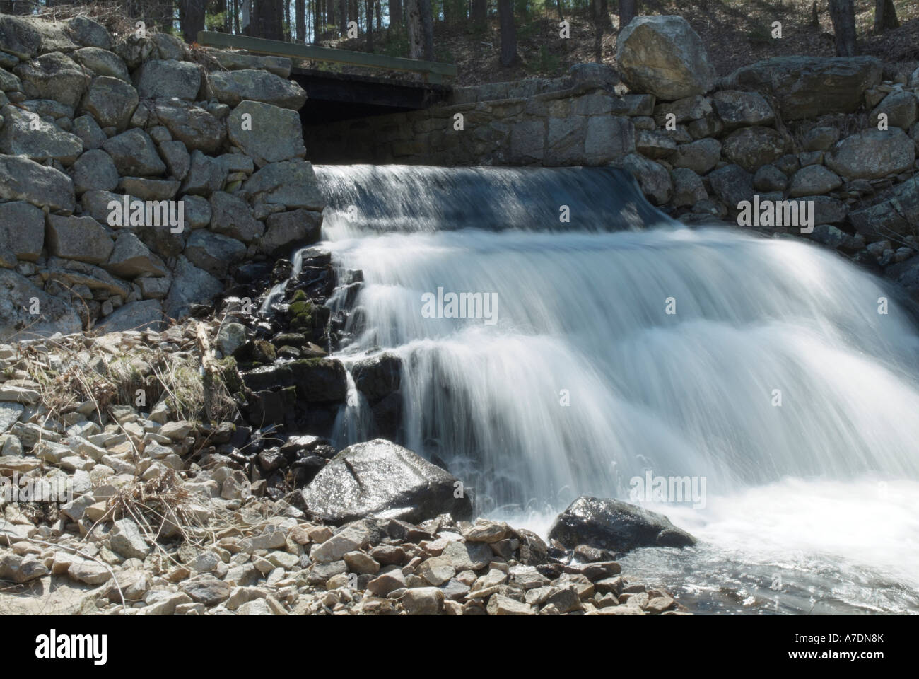 Rushing water flowing over a small dam in New Hampshire USA which is ...