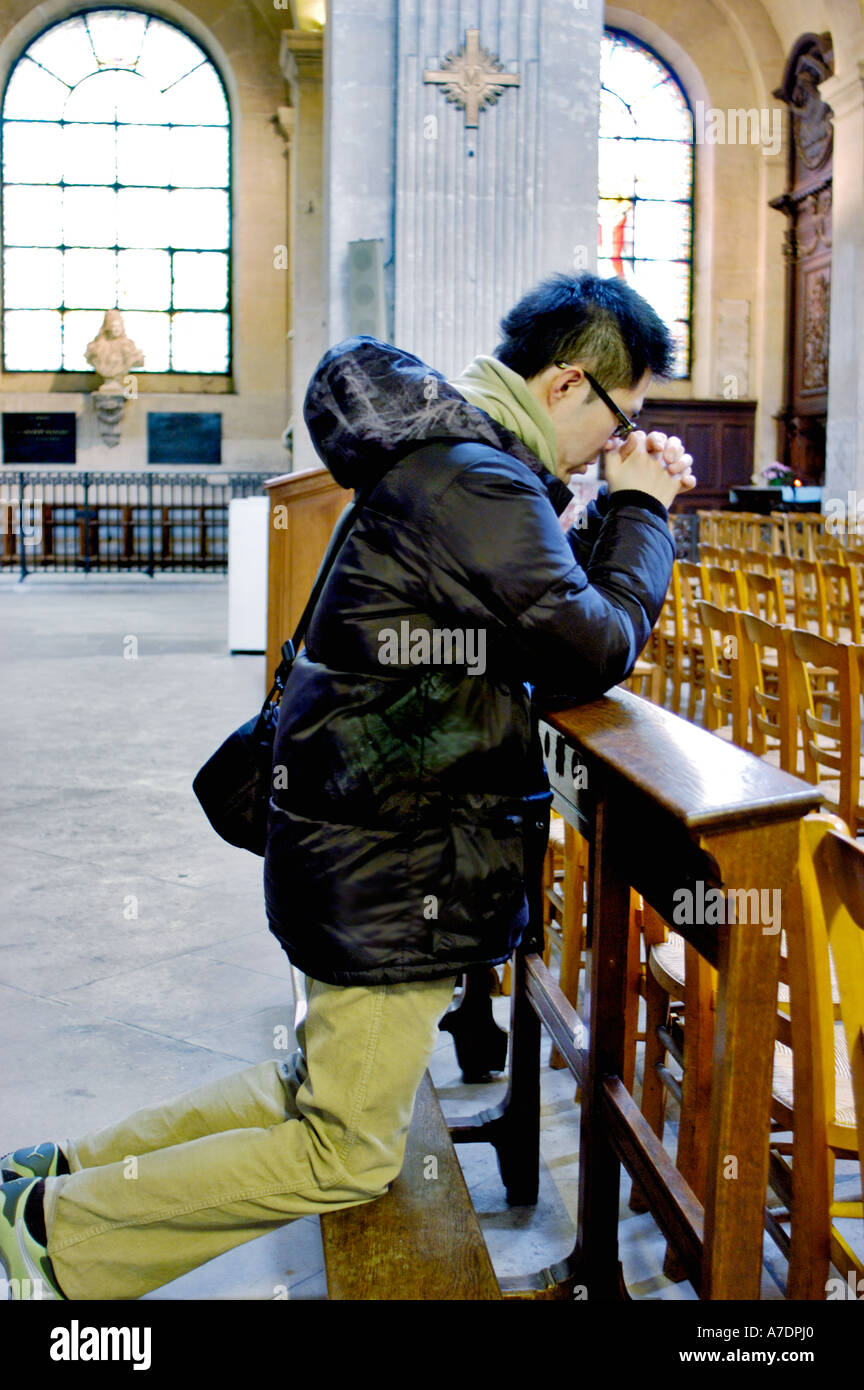 Religion Ver-sailles France, Notre Dame Church, Young Asian Man praying ...