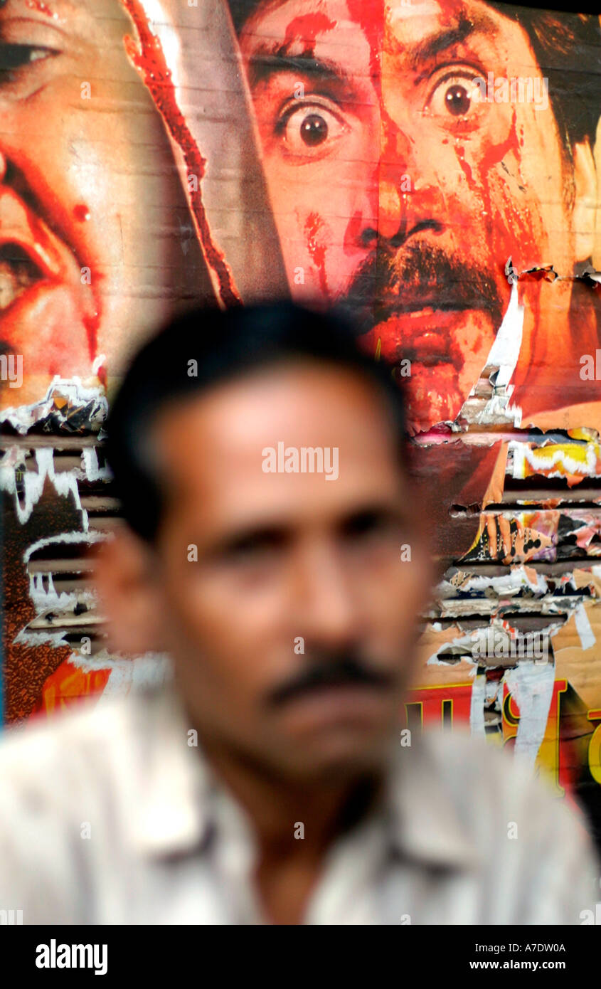 a blurred man in front of india film posters Stock Photo - Alamy