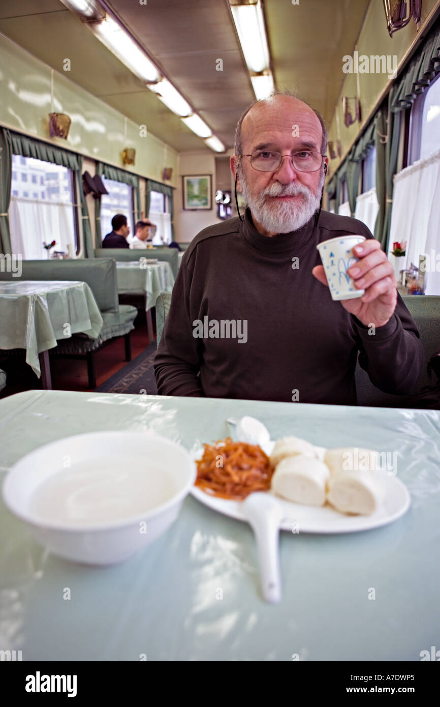 CHINA WUHAN Western tourist with typical Chinese breakfast served on ...