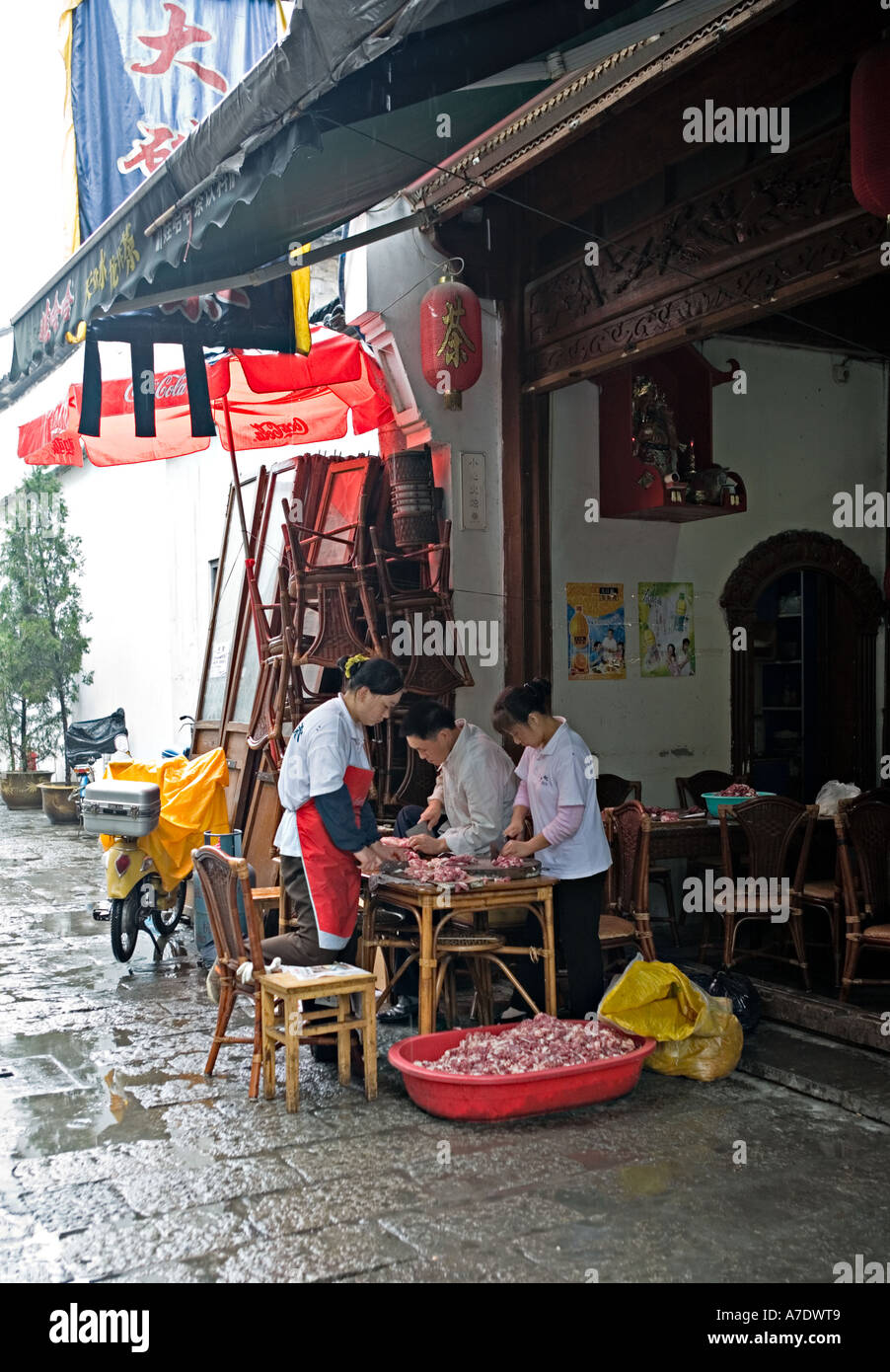 CHINA WUHAN Restaurant workers cutting meat for kabobs on tables ...