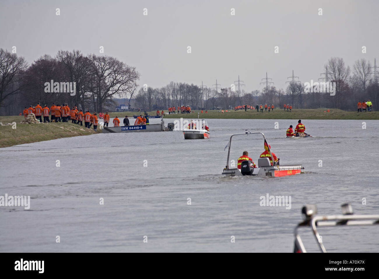 DLRG boats in activity on river Elbe, field helper protecting dam ...