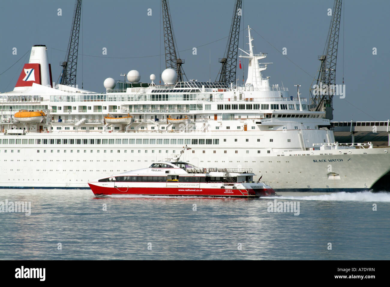 Red Jet 4 on Southampton Water passing Black Watch cruise ship England ...