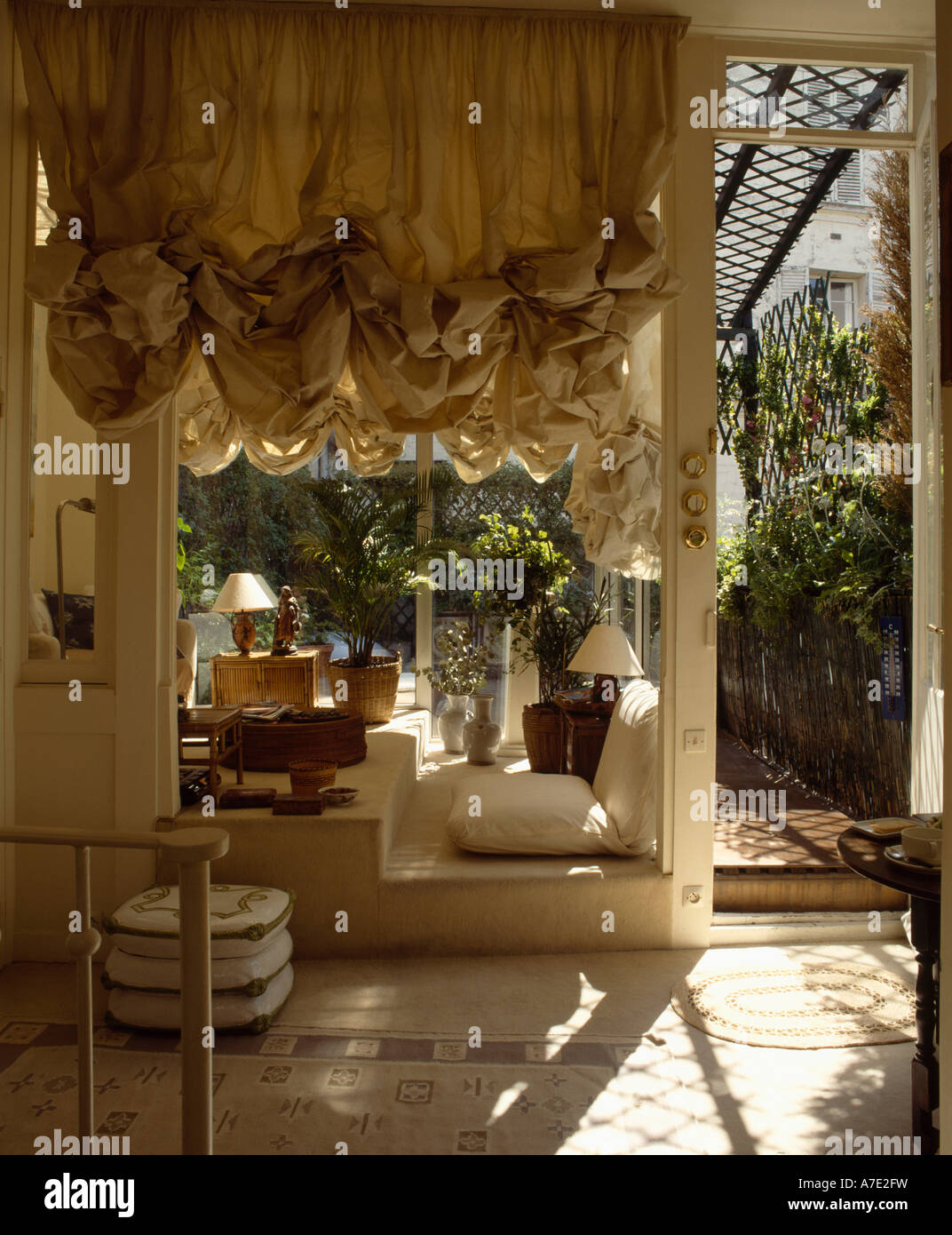 Hall with festoon blind at window into conservatory extension Stock ...