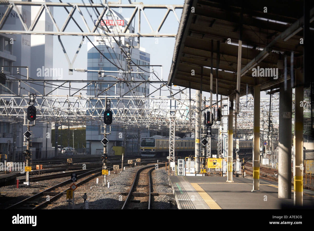 Train on railways lines with overhead power gantries on line from ...