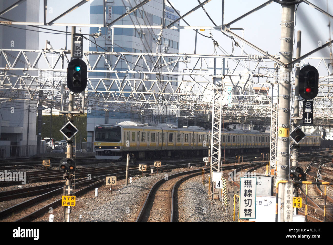 Train on railways lines with overhead power gantries on line from ...