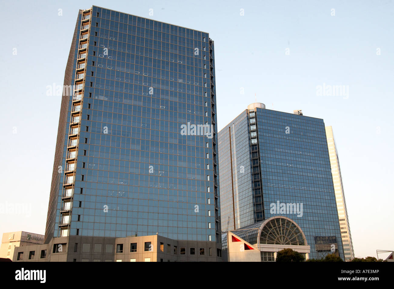 Tall modern commercial office buildings at dusk in city of Tokyo Japan ...