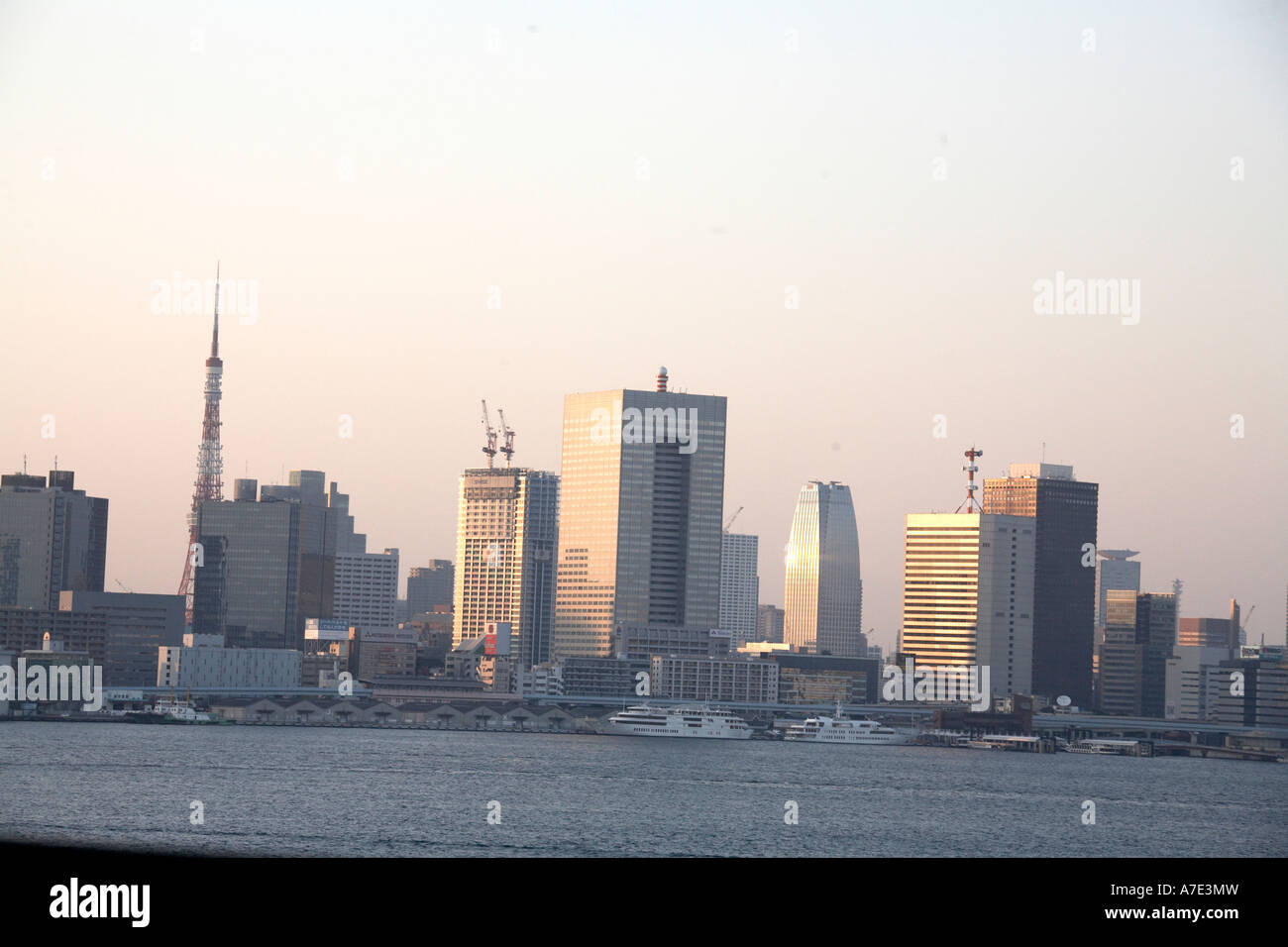 Tall modern commercial office skyscraper buildings at dusk across water ...