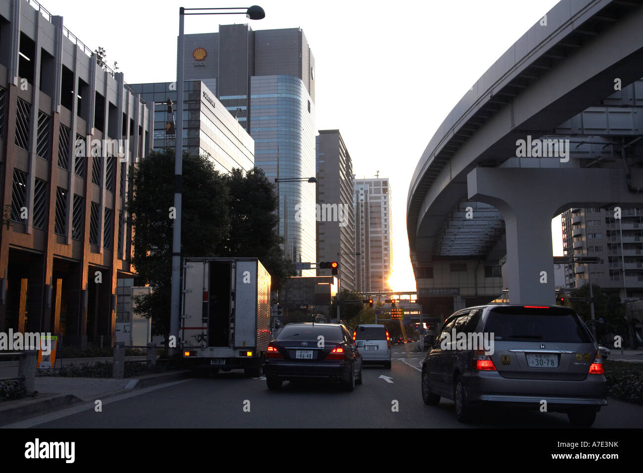 Road traffic flyovers and buildings of Daiba at dusk in city of Tokyo ...