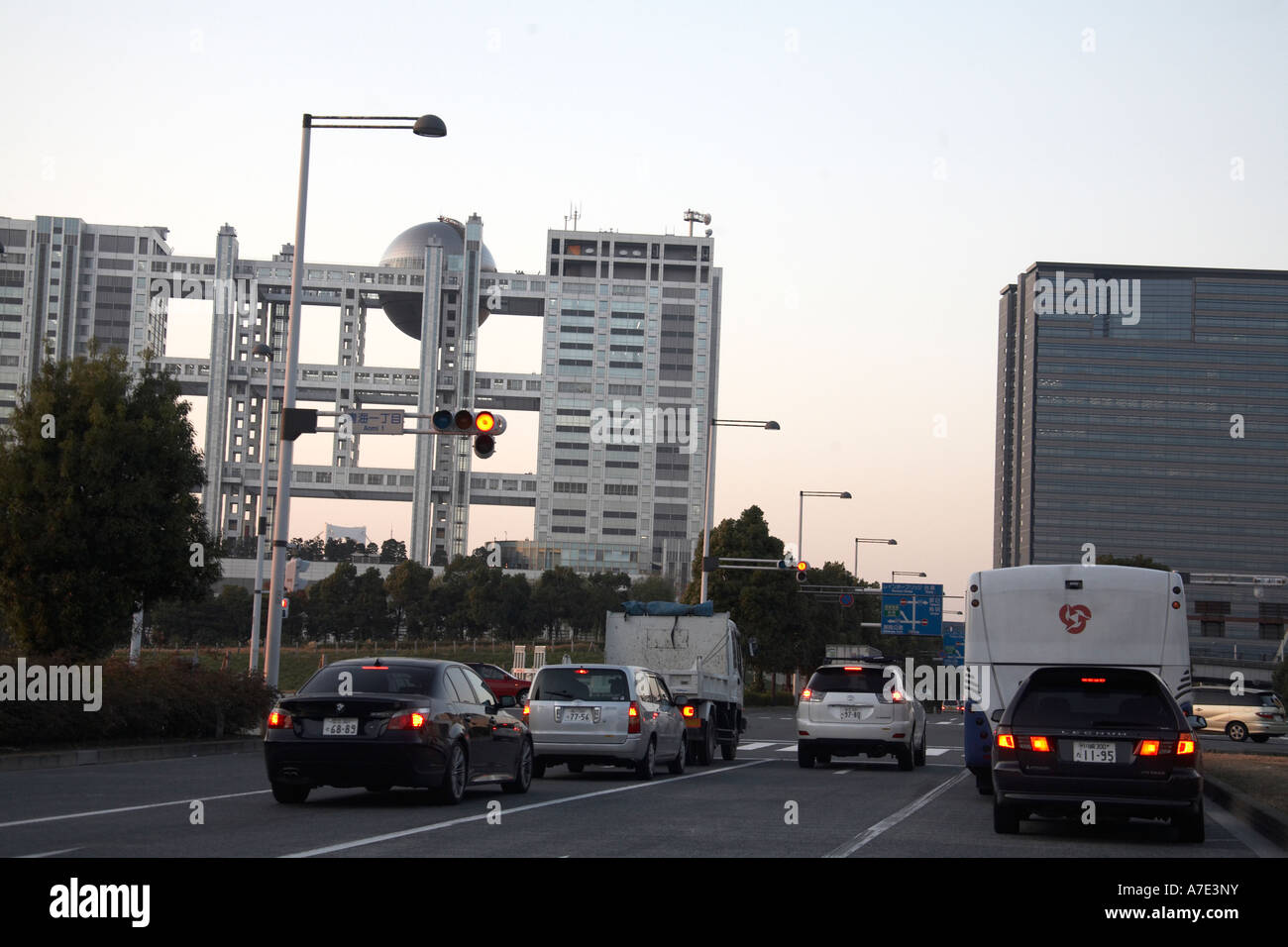 Fuji Television modern building with sphere and road traffic at dusk in ...