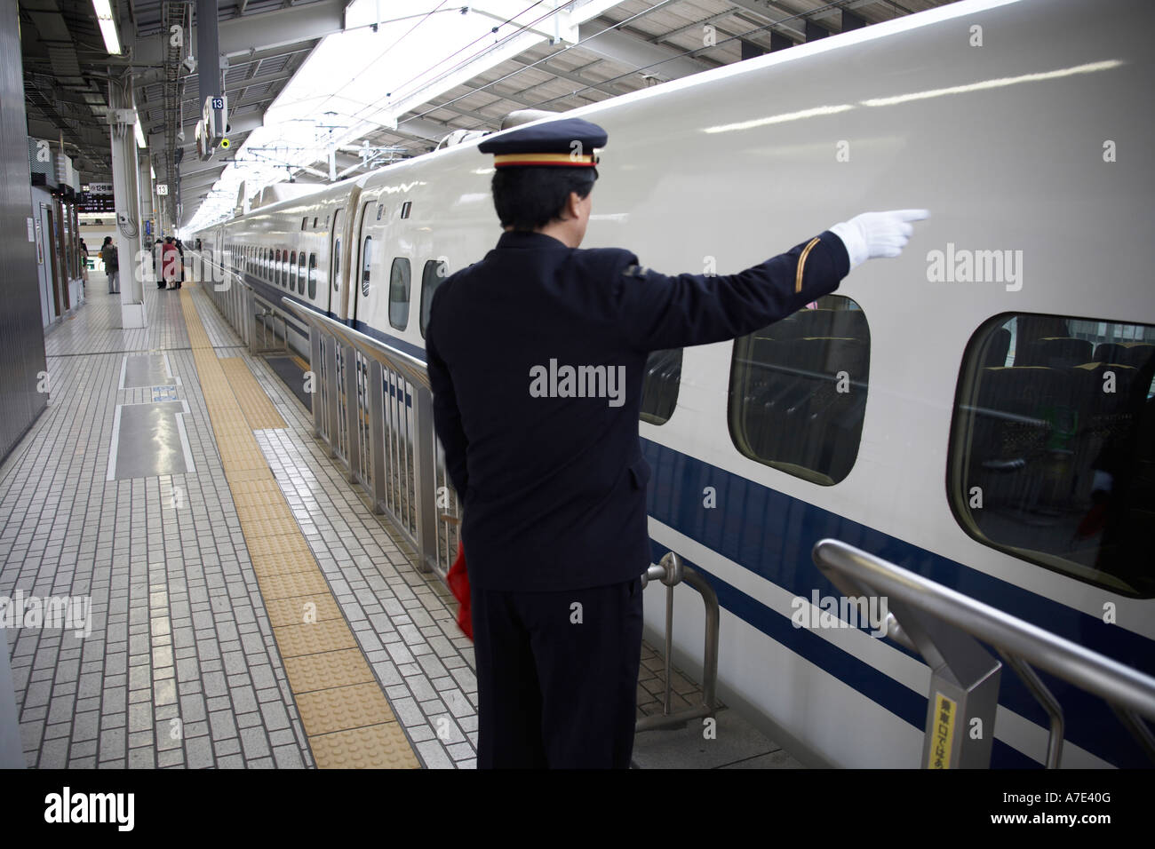 Japan Railways Shinkansen Super express Bullet train and platform guard ...
