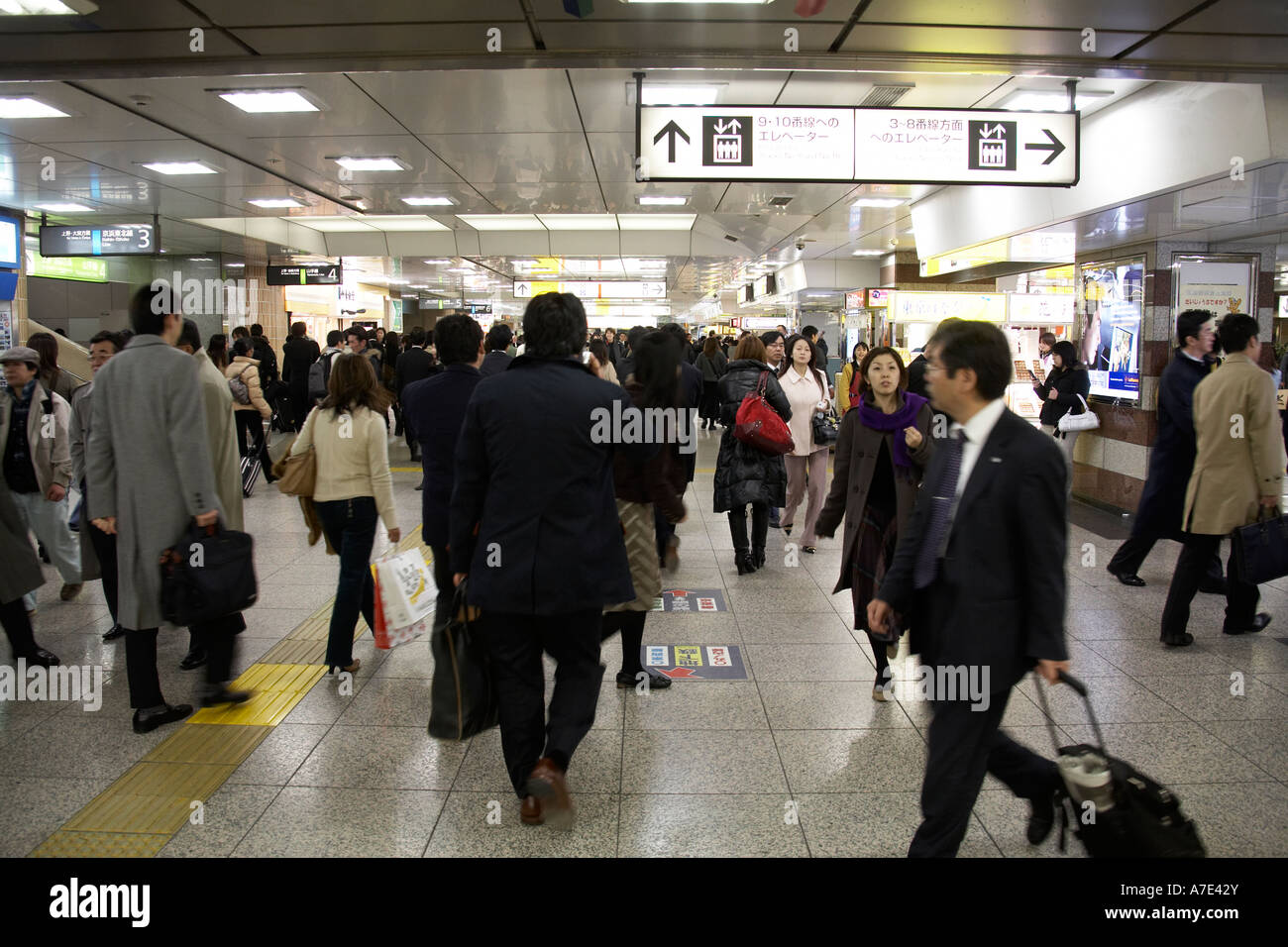 Railway rush hour commuter passengers walking in subway level of Tokyo ...