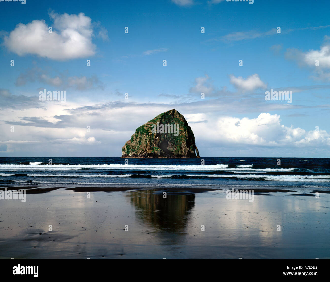 Haystack Rock sits offshore in the Pacific Ocean at Pacific City on the ...