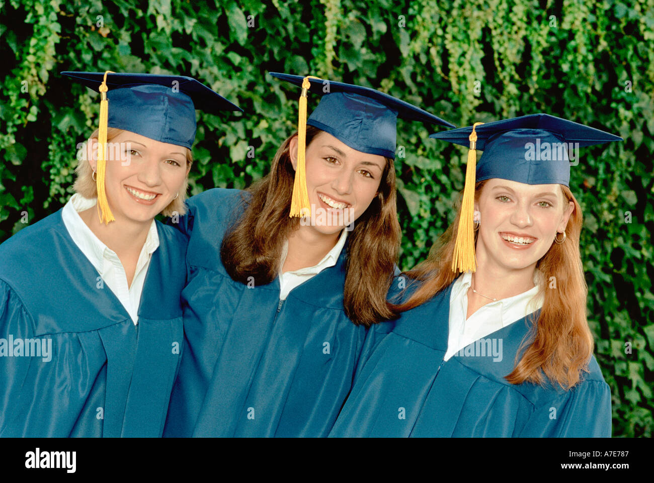 Portrait of three female graduates, smiling Stock Photo - Alamy