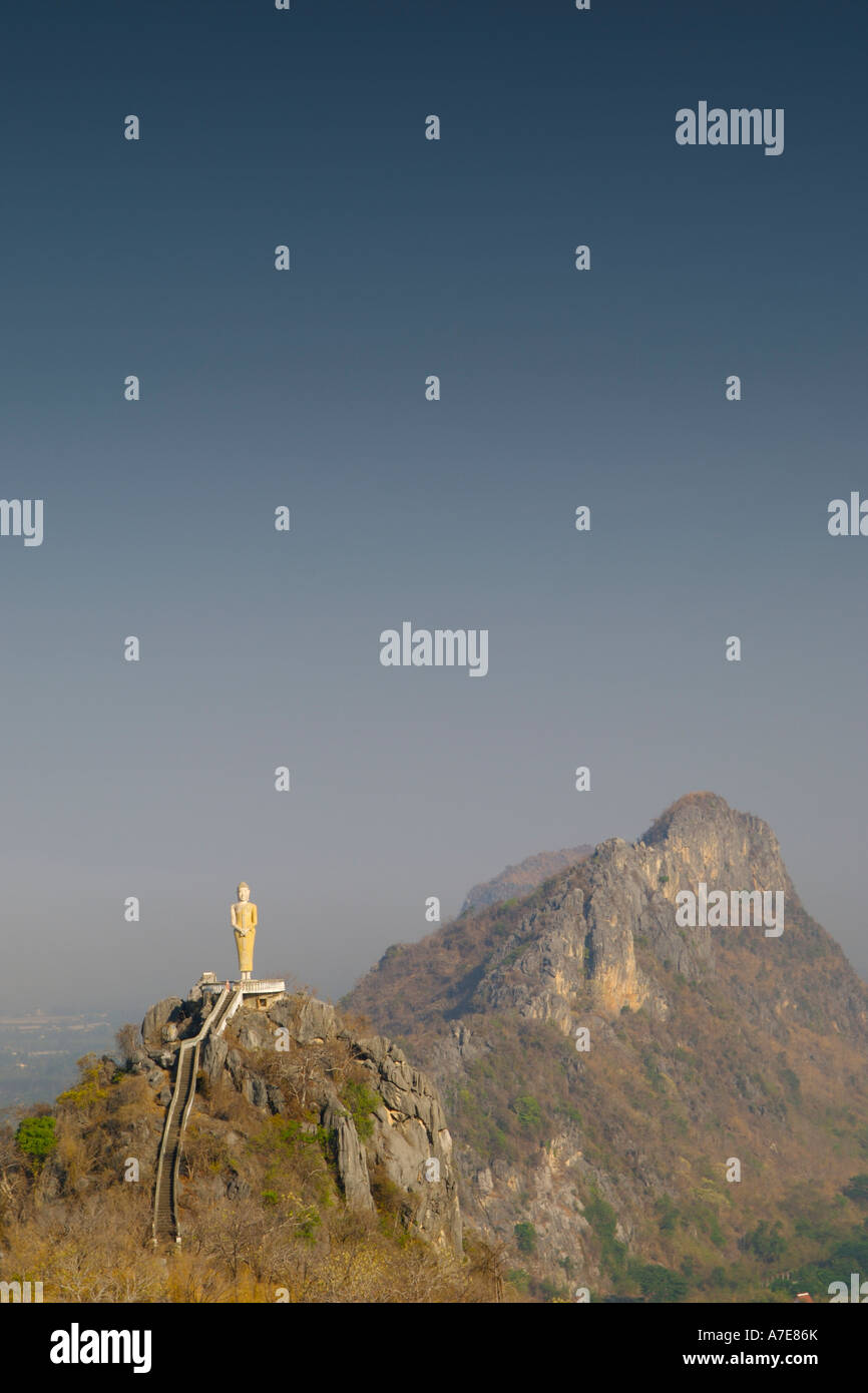 A Buddha statue on top of a mountain pass at Wat Khao Tham Talu in ...