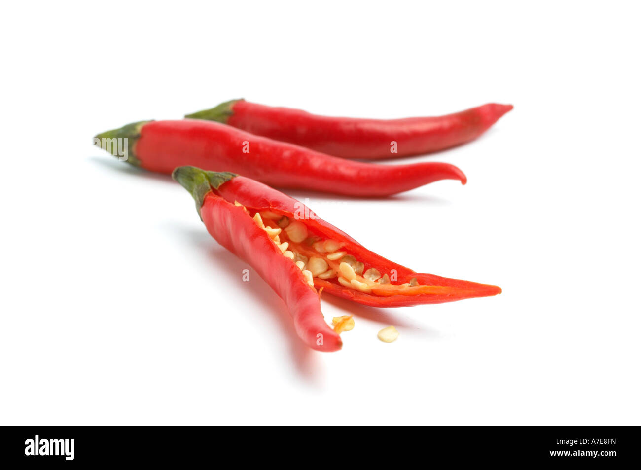 Three Red Bird s Eye Chillies one cut open showing seeds Stock Photo ...