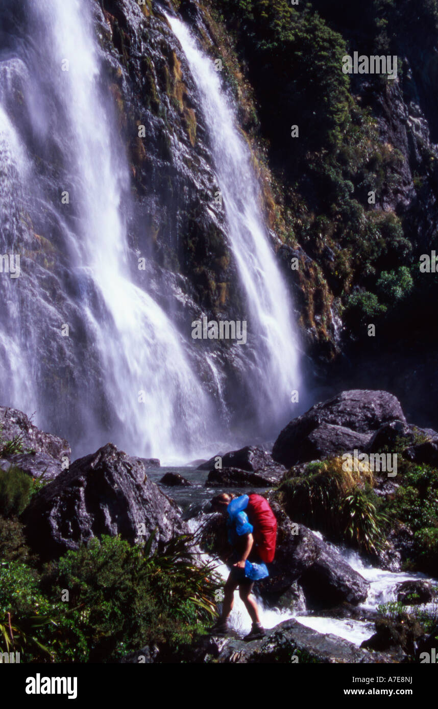 Hiker on The Routeburn Track crossing Earland Falls Stock Photo - Alamy