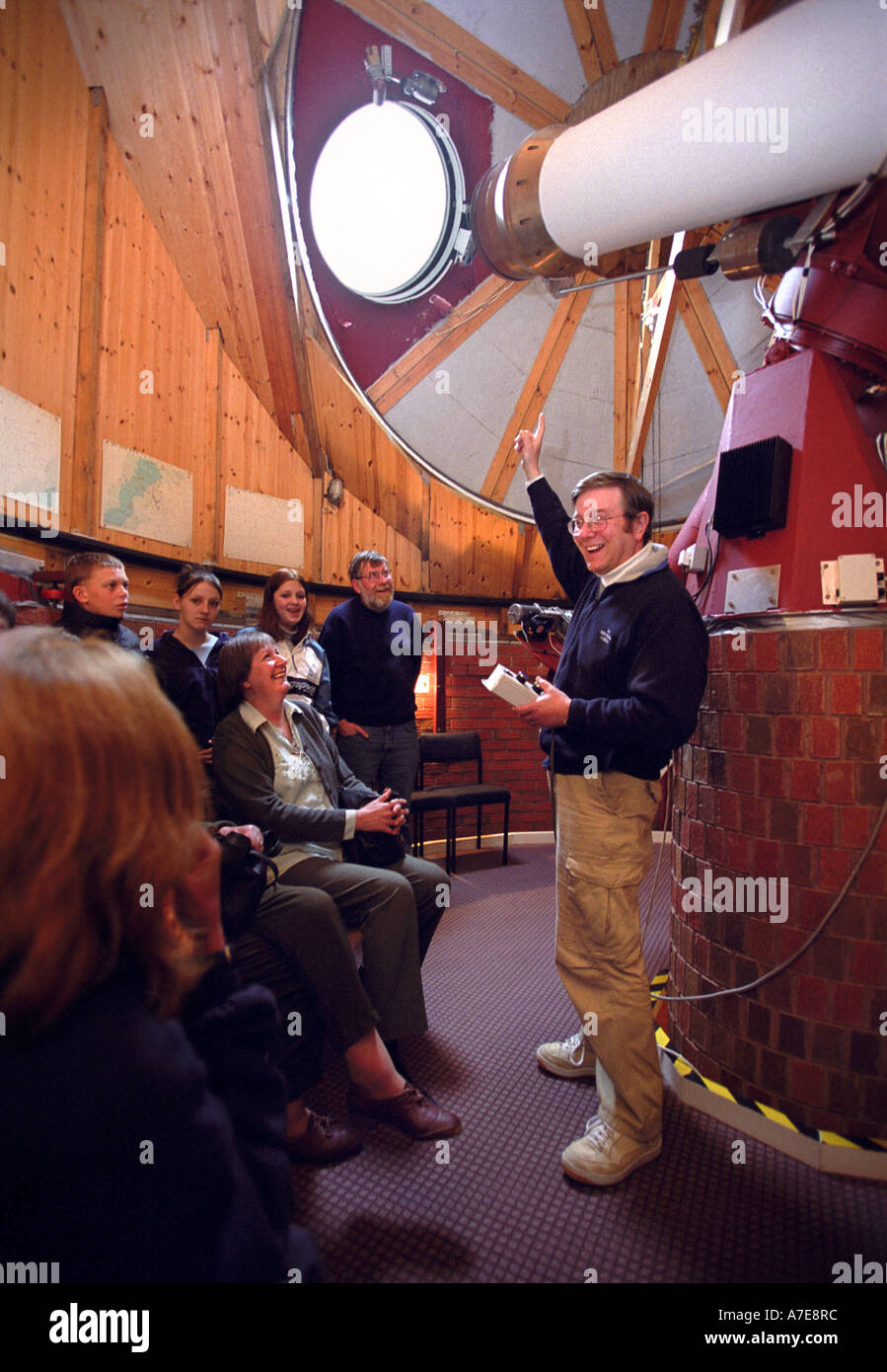 JAY TATE DIRECTOR OF THE SPACEGUARD CENTRE SHOWING VISITORS A TELESCOPE ...
