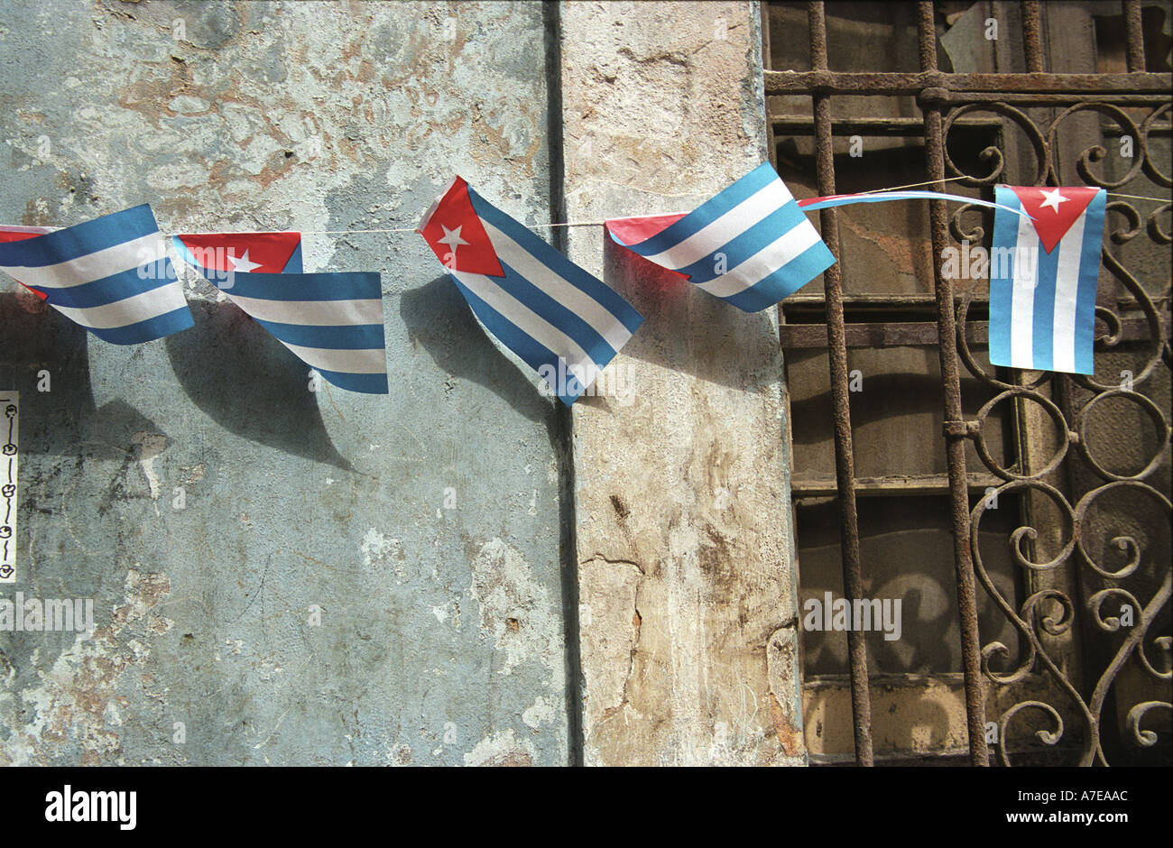 Cuban flags decorate the colour faded walls of havana buildings in ...