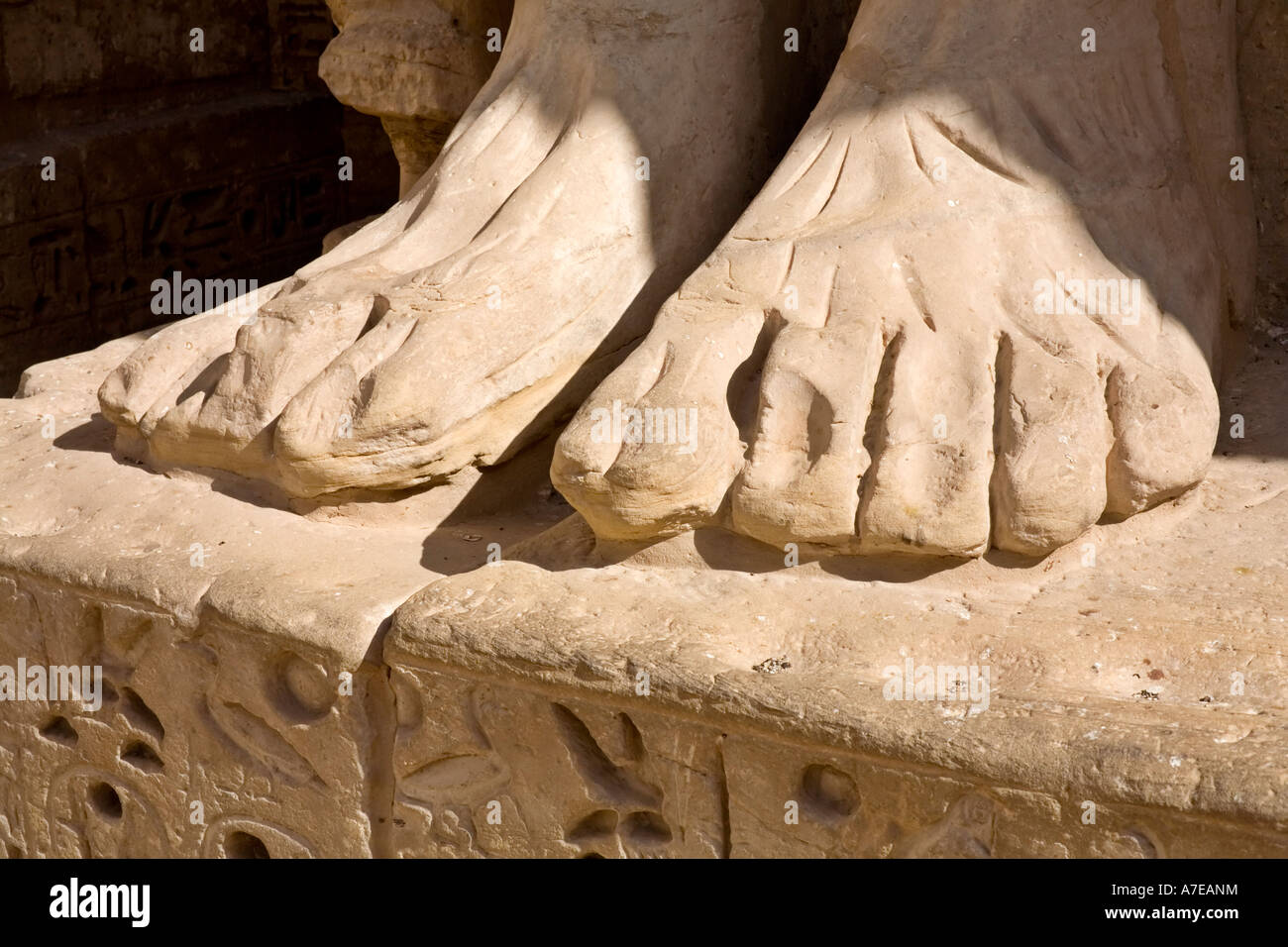 The well worn feet of a pharonic statue at Medinet Habu temple Egypt ...