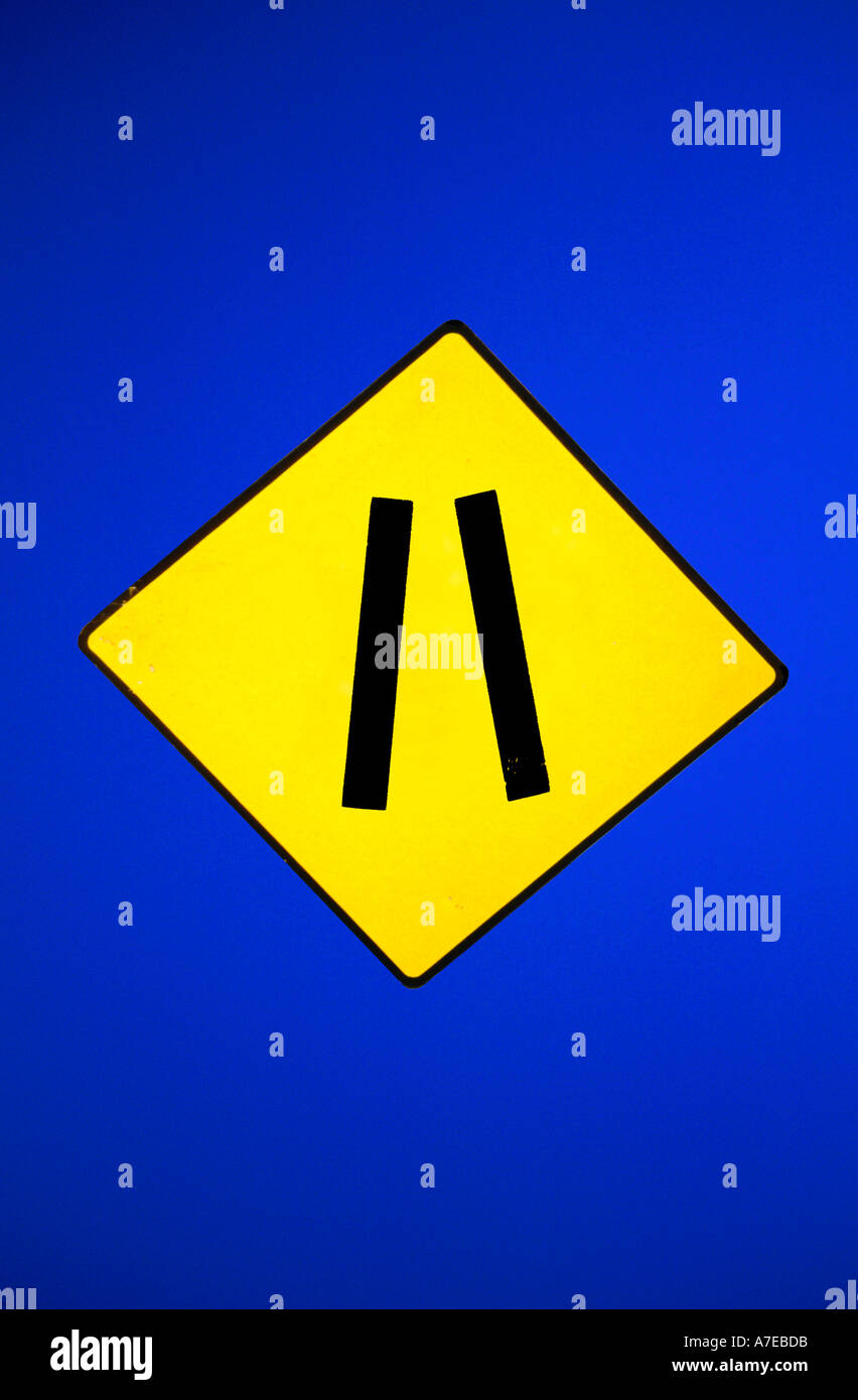 Yellow road sign with steep hill symbol on blue background Portrait ...