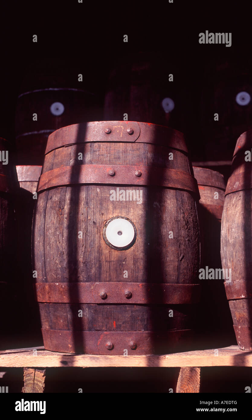Oak kiln casks stored behind iron gates of Wadworth brewery, Devizes ...