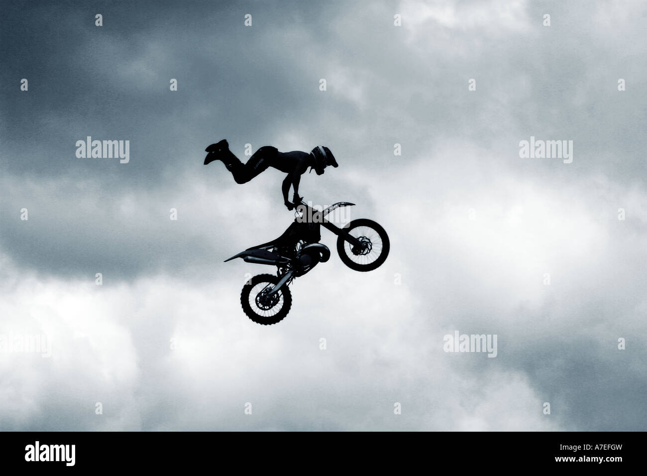 Dare devil motocross man on motor bike jumping into the air - No ...