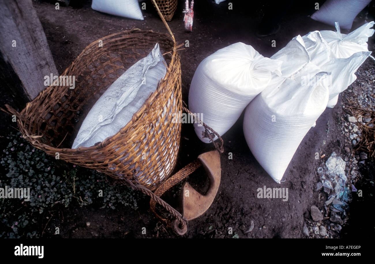 Sacks of rice next to a woven back pack on the ground Stock Photo - Alamy