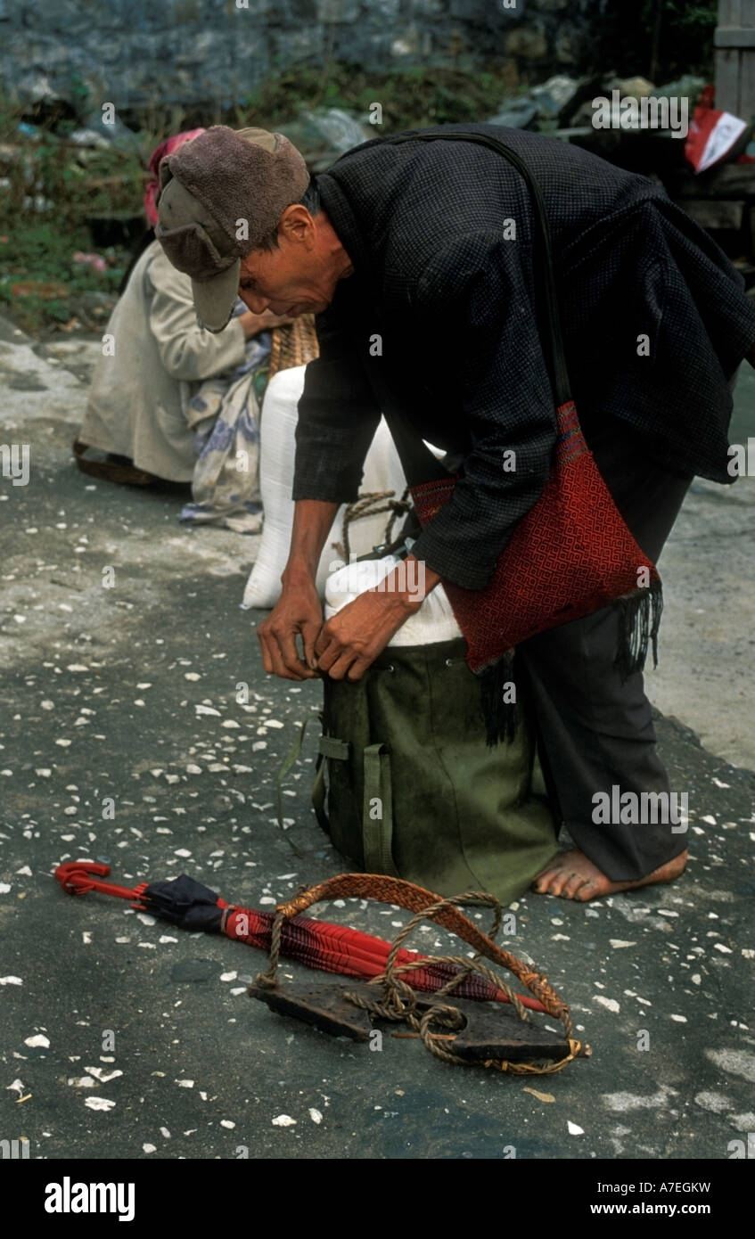 Old man loading a sack of rice into his backpack Stock Photo - Alamy