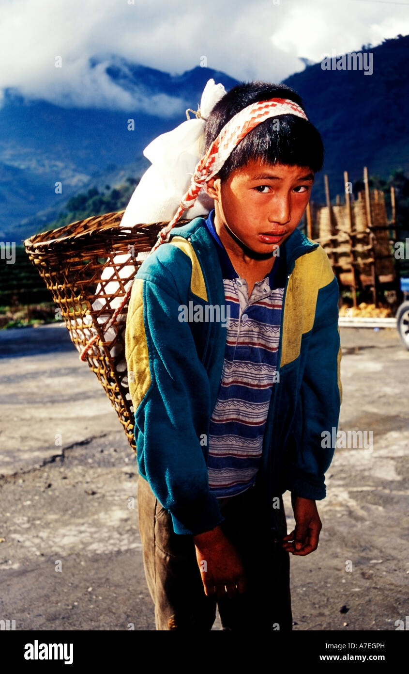 Boy with a sack of rice in woven bamboo pack on his back Stock Photo ...