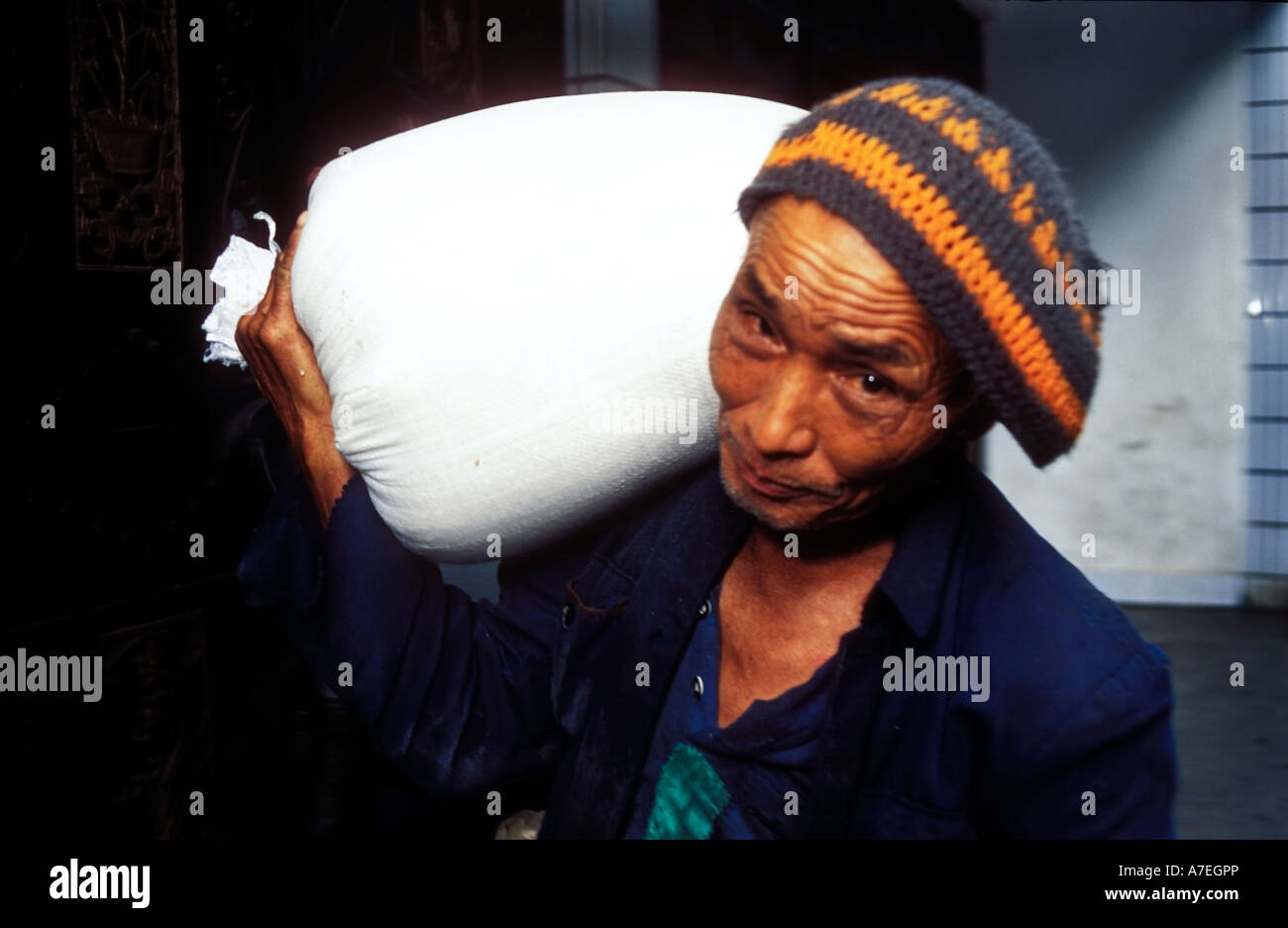 Man carrying heavy bag rice hi-res stock photography and images - Alamy