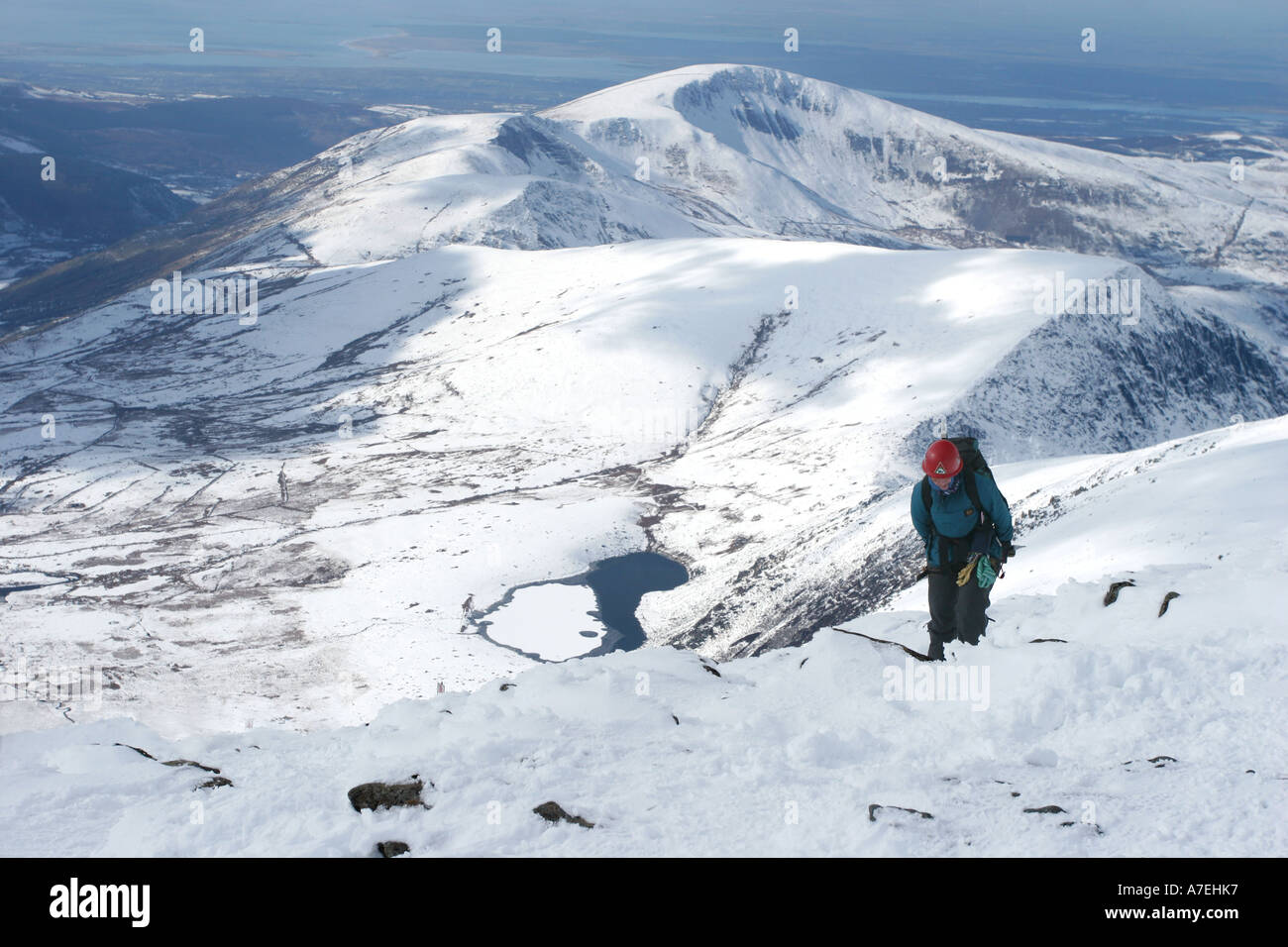 A mountaineer just below the snow covered summit of Snowdon the highest ...