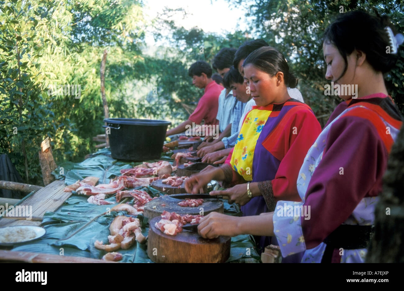 Traditionally dressed Lisu women preparing food at a gathering in ...