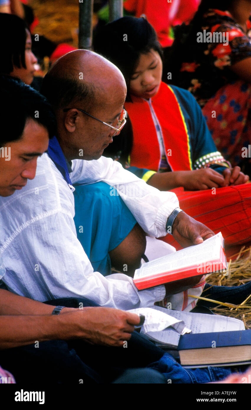 Asian men at a conference reading from books Stock Photo - Alamy