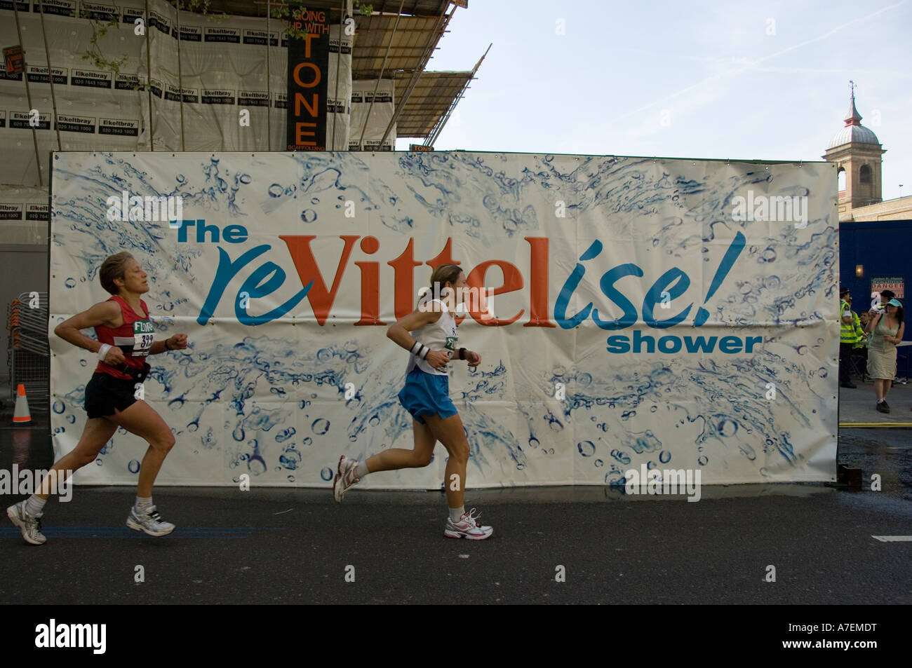 Runners passing a water shower at the Flora London Marathon 2007 Stock ...