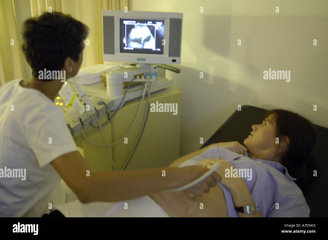 pregnant woman female montior screen maternity ante natal clinic ...