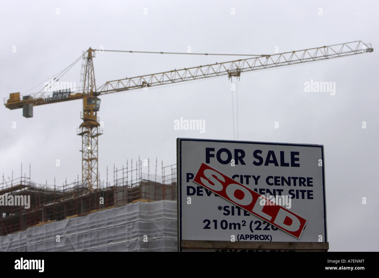 crane on construction building site behind sold notice put across for ...