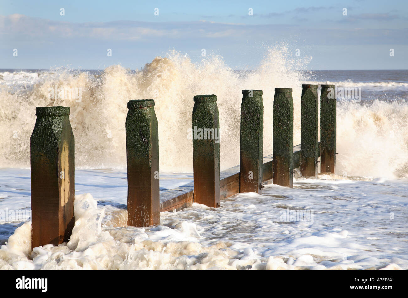 Breakwater with Crashing Wave Stock Photo - Alamy