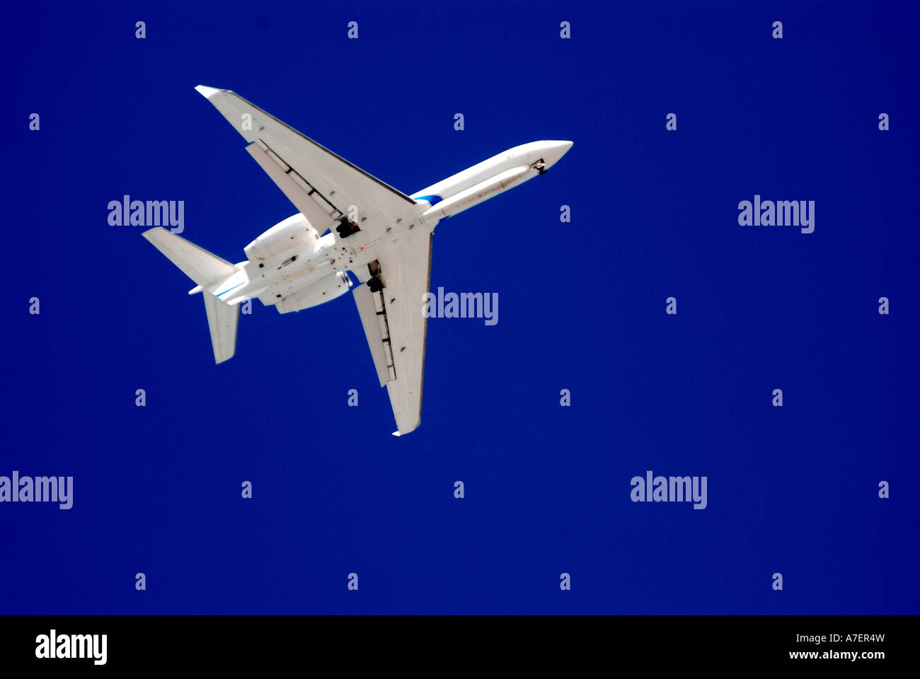 White jet plane on dark blue sky background coming in to land Stock ...