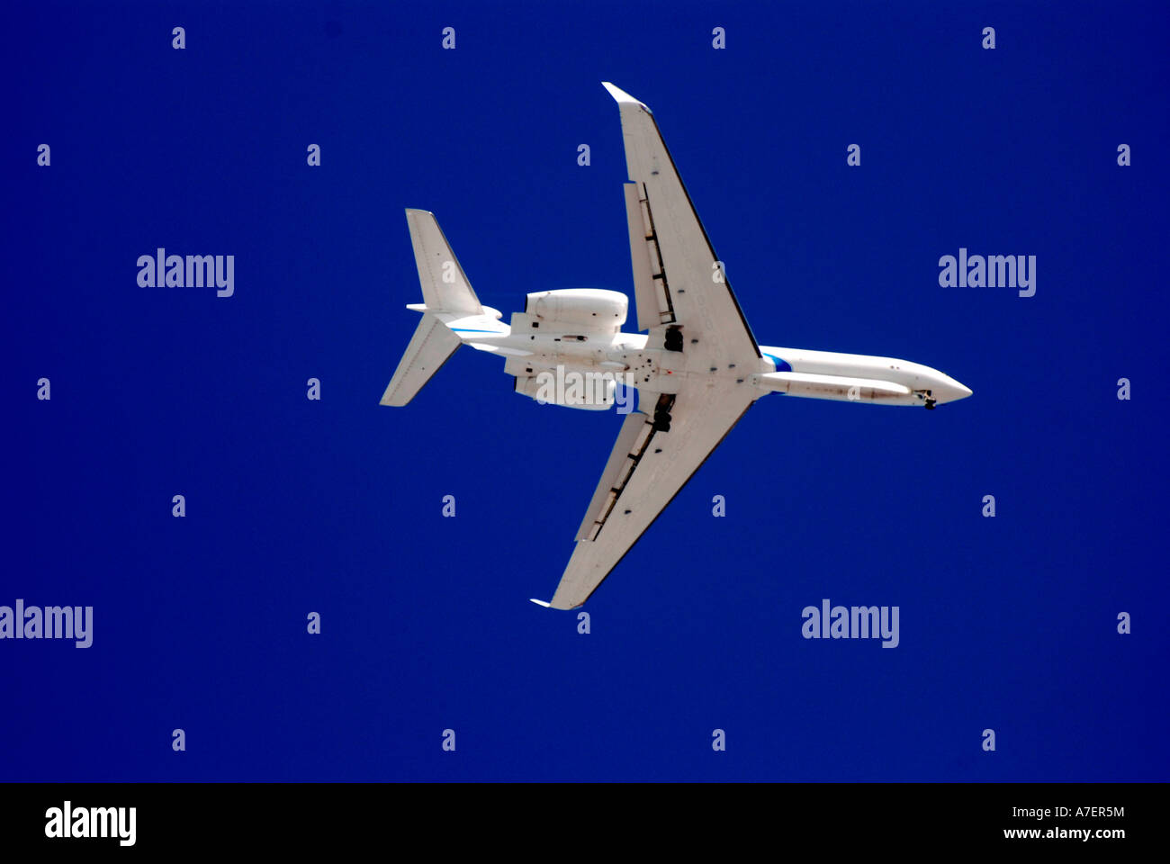 White jet plane on dark blue sky background coming in to land Stock ...